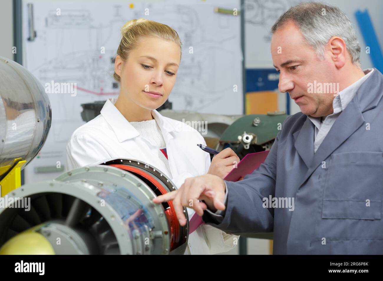 teacher showing student a problem in the engine Stock Photo - Alamy