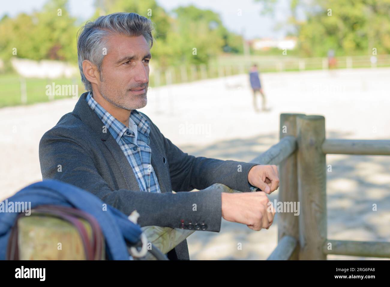 Man stood by wooden railing Stock Photo - Alamy