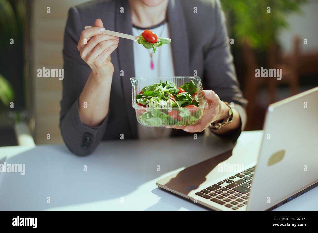 Sustainable workplace. Closeup on woman worker in a grey business suit ...