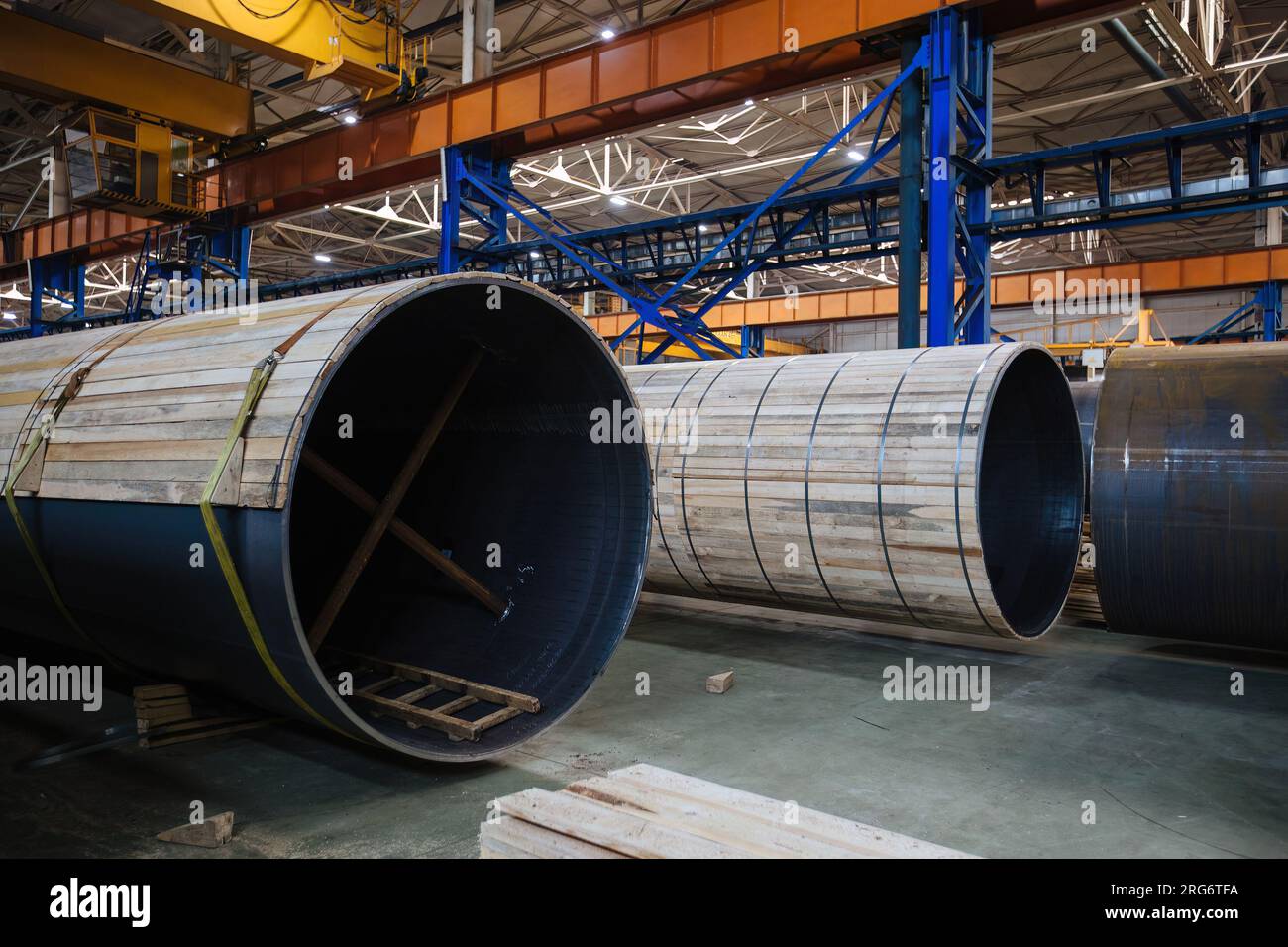 New steel pipes packed in wooden formwork in warehouse Stock Photo - Alamy