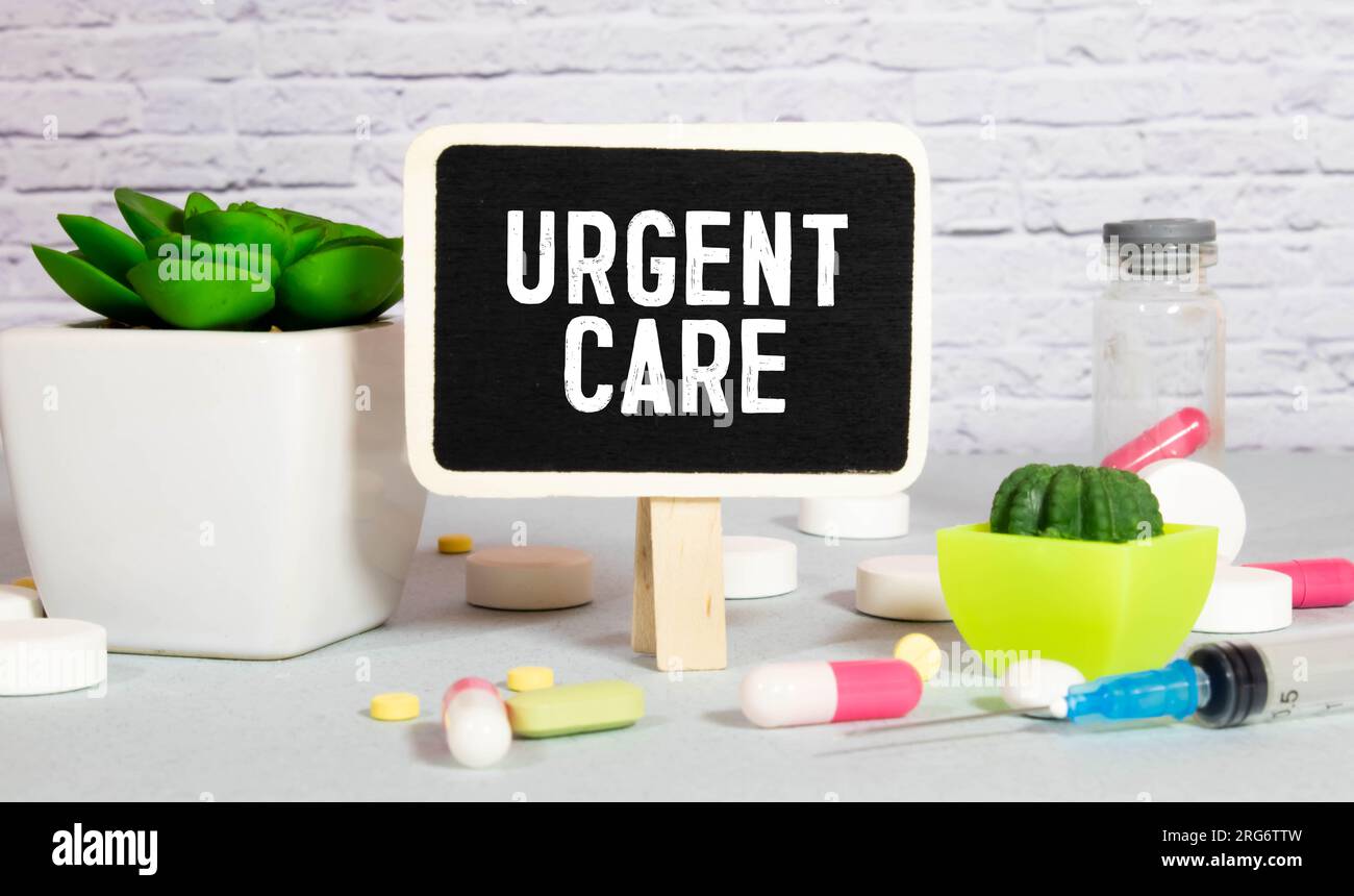 White notepad with the words URGENT CARE and a stethoscope on a blue ...