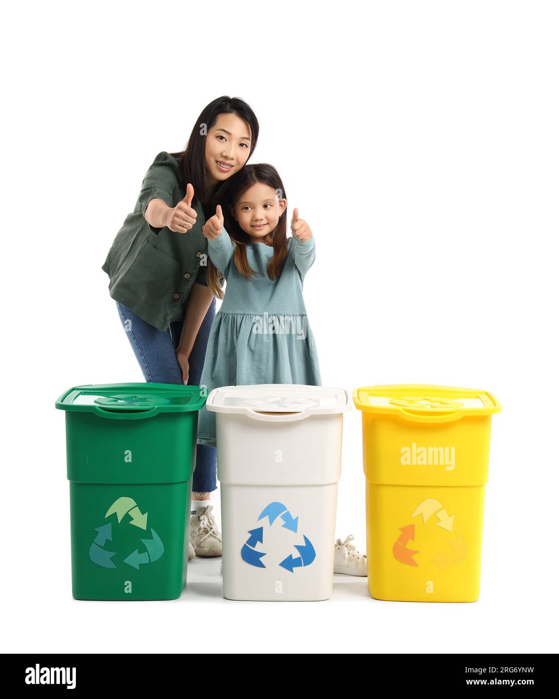 Asian mother with her little daughter and recycle bins showing thumbs ...