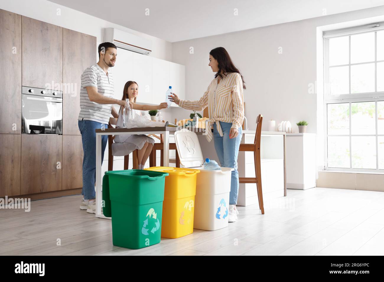 Mother daughter sorting recycling waste kitchen hi-res stock ...