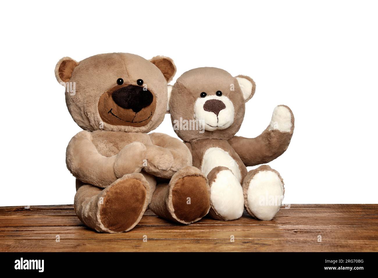 Cute teddy bears on wooden table against white background Stock Photo ...