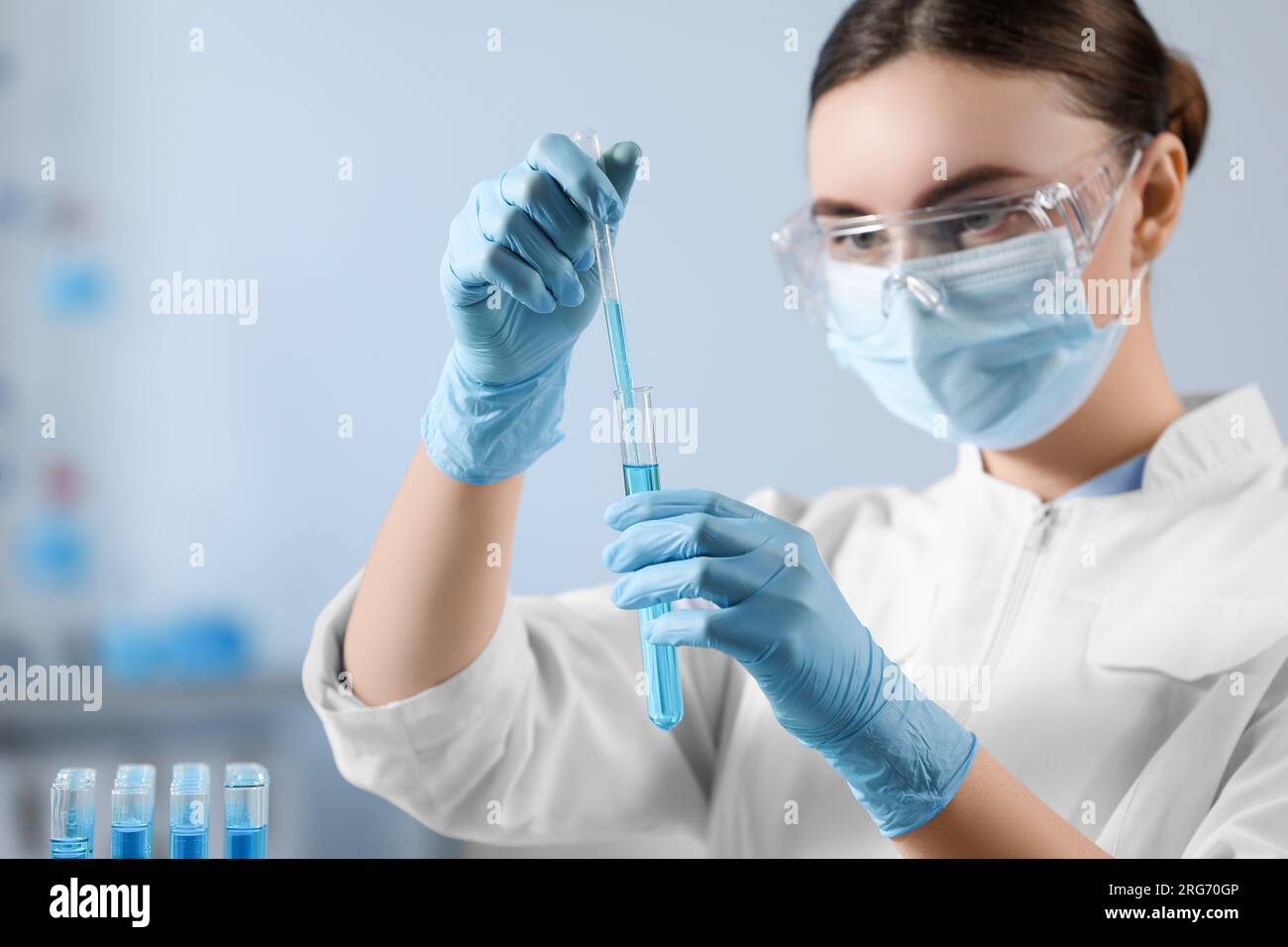 Scientist taking sample with dropper from test tube in laboratory Stock ...