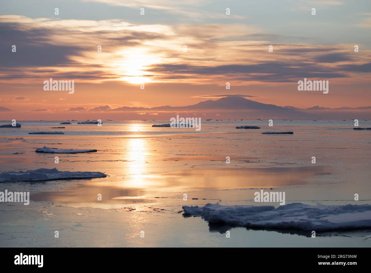 Sunrise over drift ice floating in frozen winter sea, Hokkaido, Japan ...