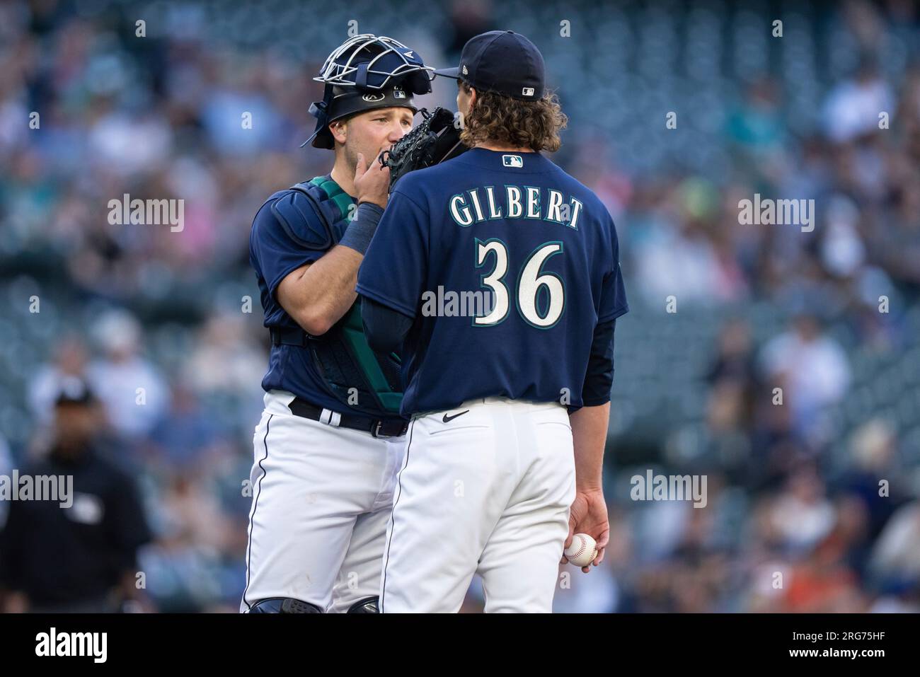 Seattle Mariners catcher Cal Raleigh, left, and starting pitcher Logan ...