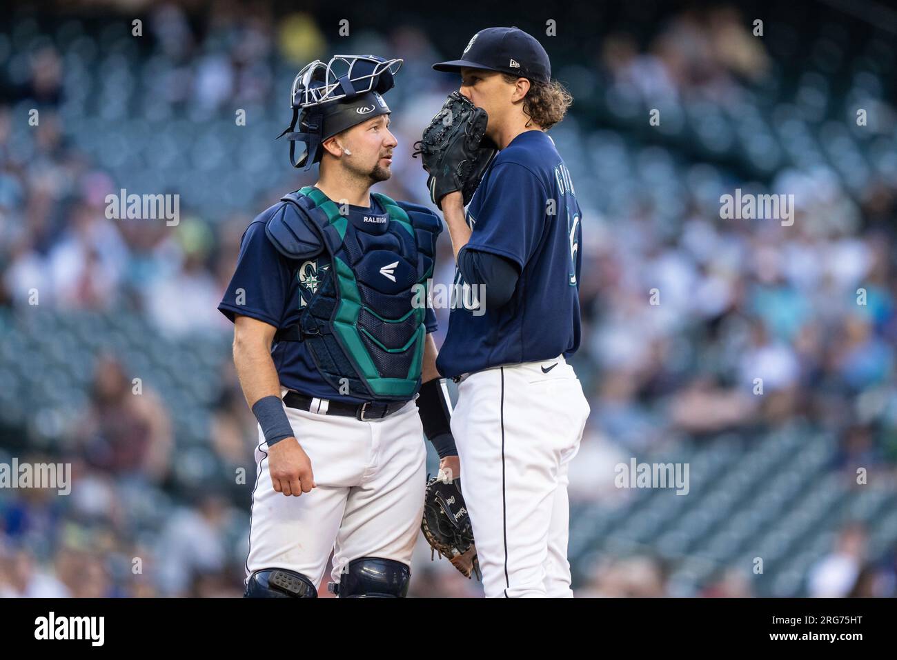 Seattle Mariners catcher Cal Raleigh, left, and starting pitcher Logan ...