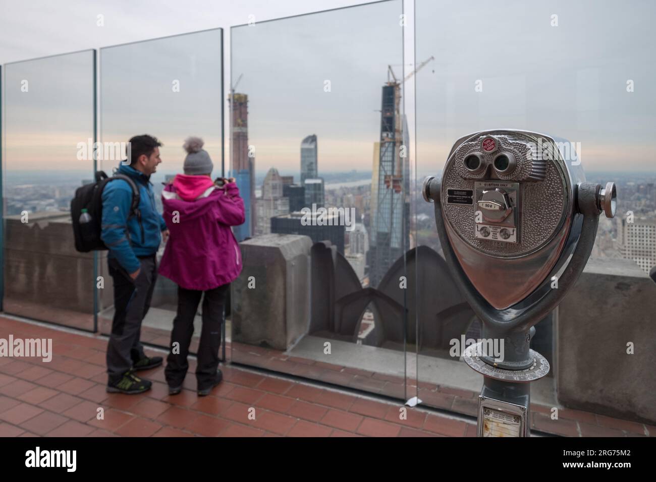 Tourist couple taking photos on the observatory terrace of the Top of ...