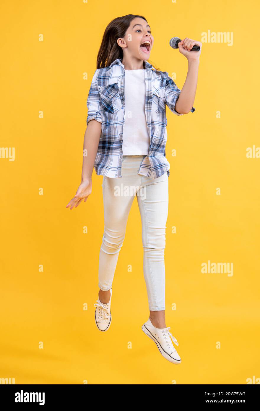 teen girl karaoke singer jump isolated on yellow. teen girl karaoke ...