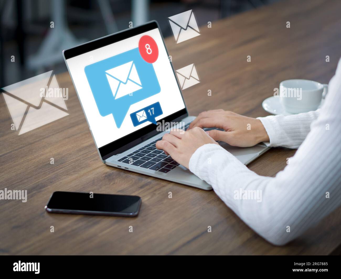 A focused woman is busy operating a laptop, surrounded by vibrant ...