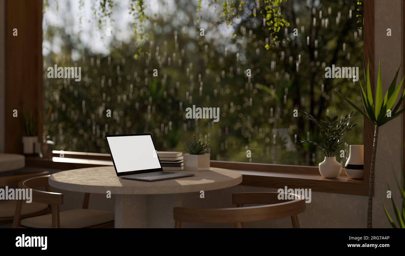 A cozy minimalist cafe or coffee shop on a rainy day, a laptop mockup ...