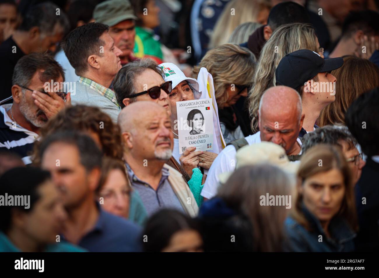 Fatima, Portugal. 5th Aug, 2023. A worshipper holds a banner with ...