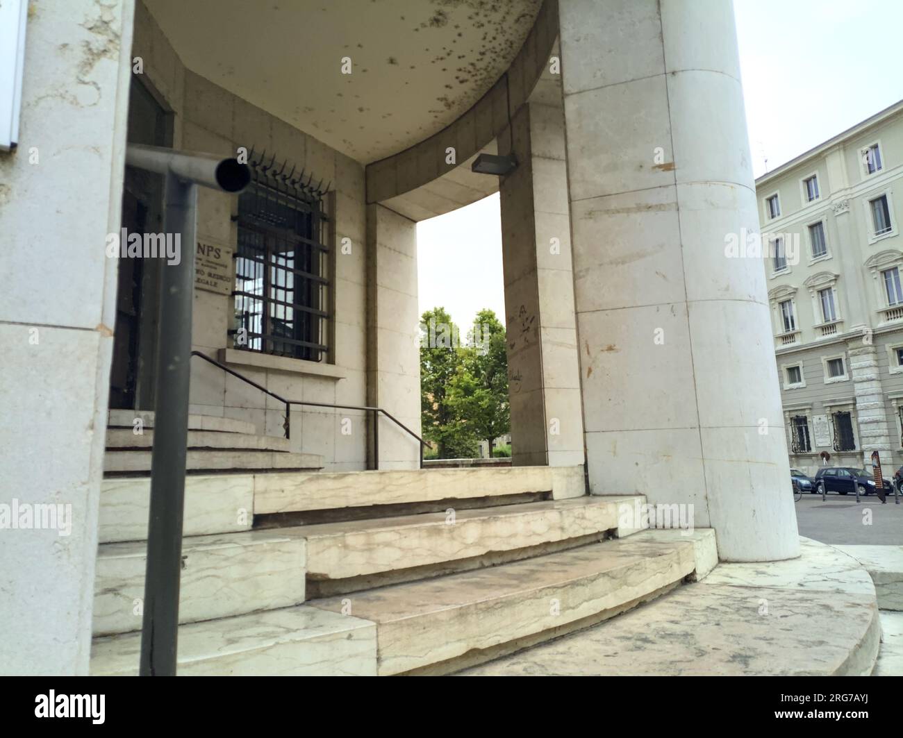 Entrance of a building with columns and a staircase in a square of an ...