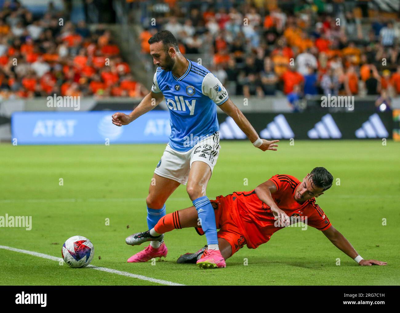 HOUSTON, TX - AUGUST 07: Houston Dynamo midfielder Amine Bassi (8) slide tackles Charlotte FC ...