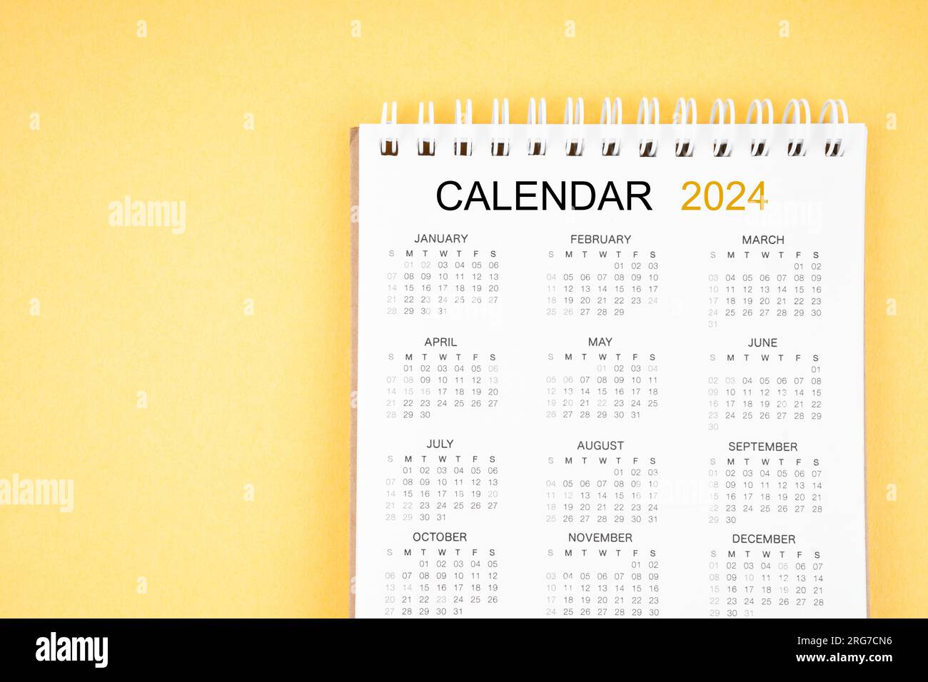 12 months desk calendar 2024 on yellow background Stock Photo - Alamy