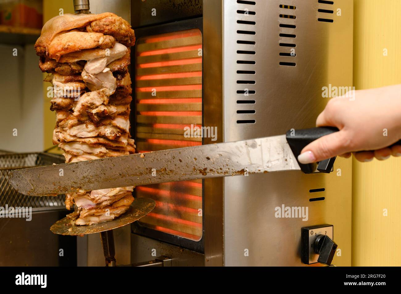Chicken meat on a vertical grill is prepared for shawarma Stock Photo ...