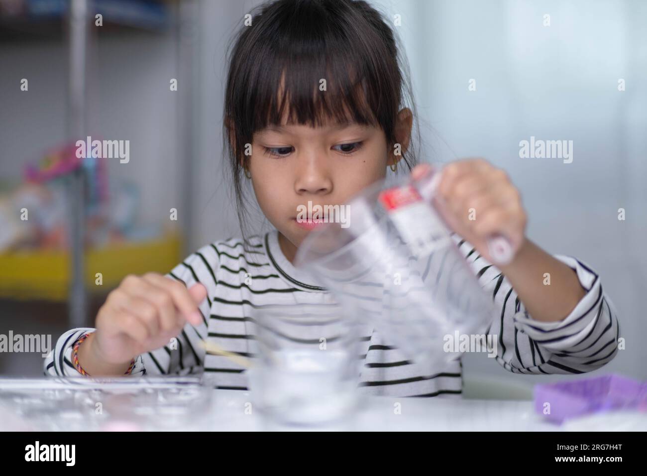 Cute little girl making DIY plaster and painting at home. Children ...