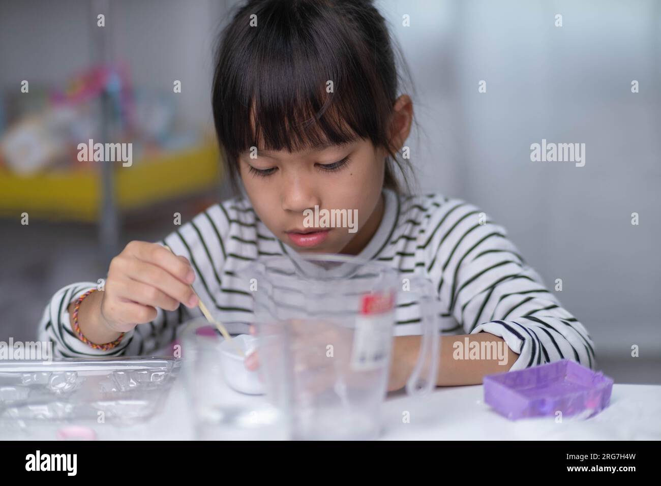 Cute little girl making DIY plaster and painting at home. Children ...