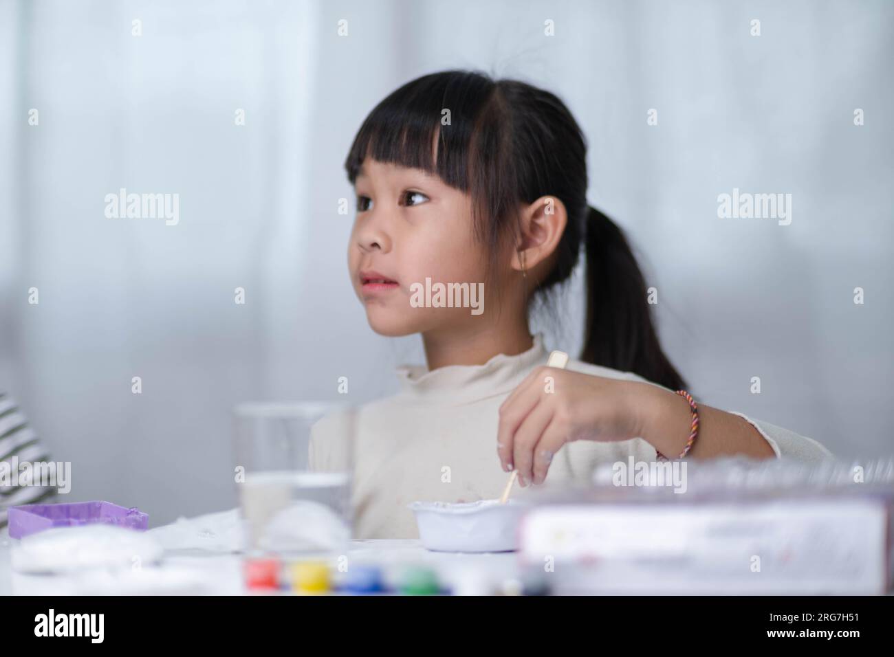 Cute little girl making DIY plaster and painting at home. Children ...