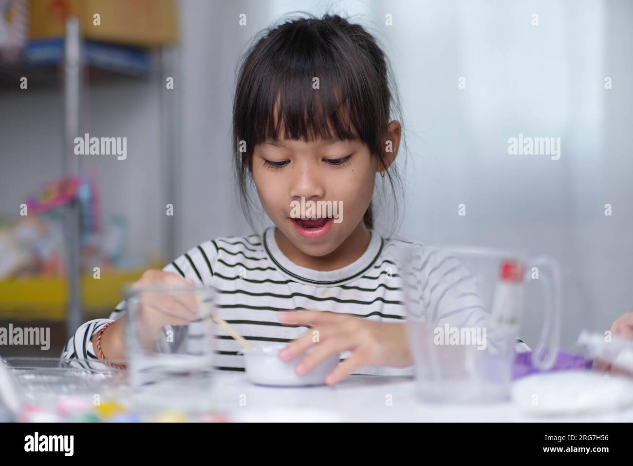 Cute little girl making DIY plaster and painting at home. Children ...