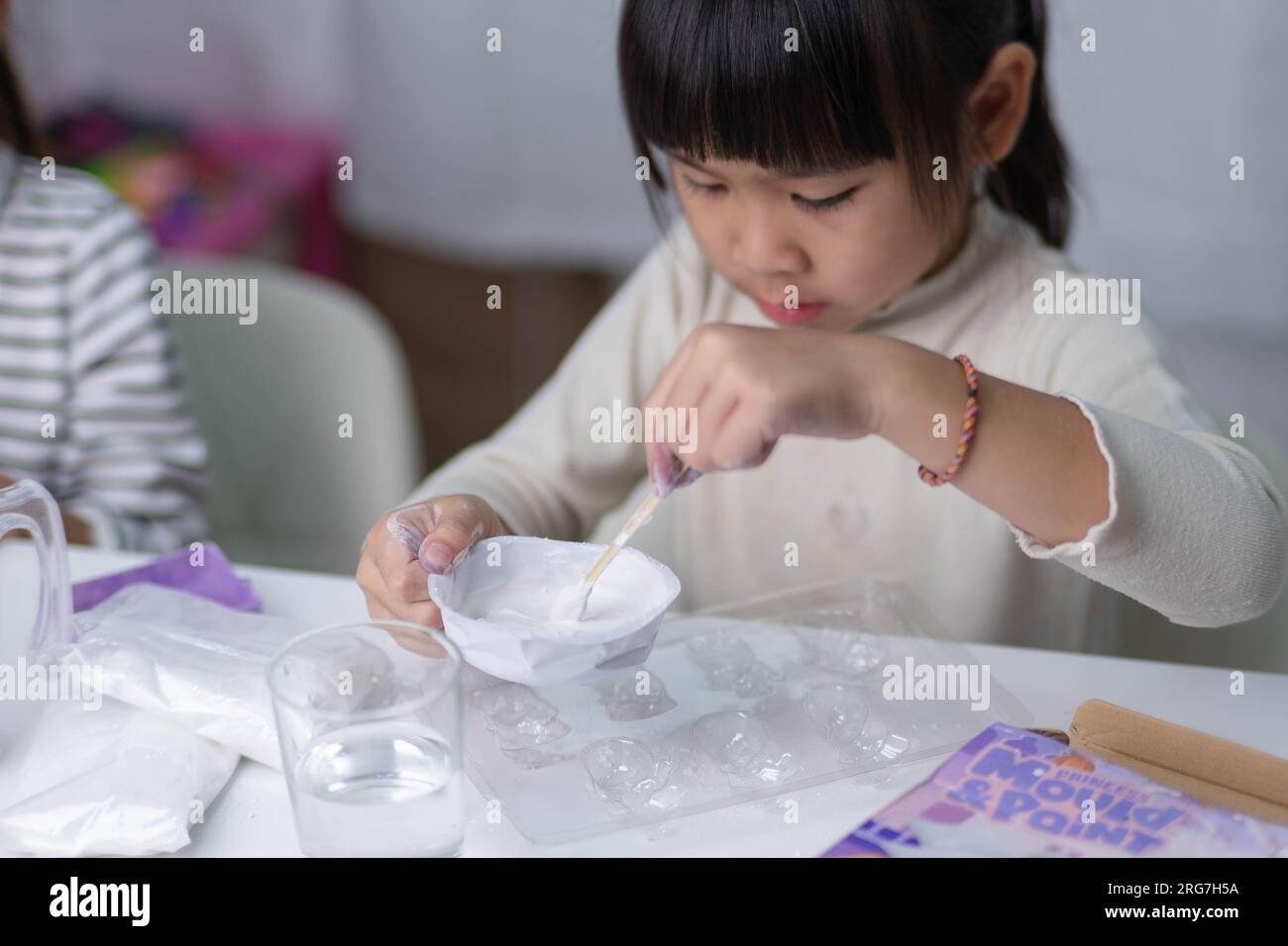 Cute little girl making DIY plaster and painting at home. Children ...