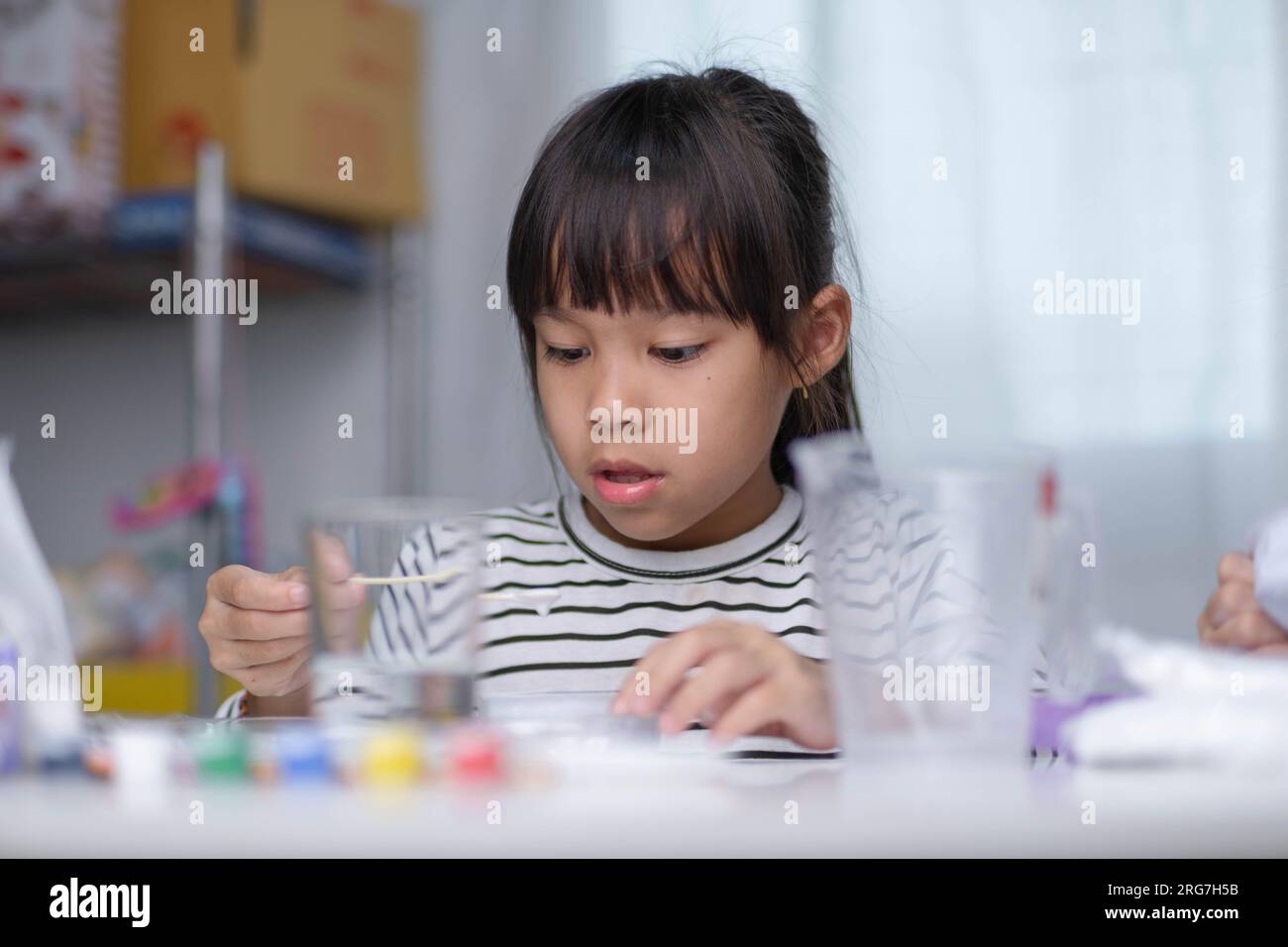 Cute little girl making DIY plaster and painting at home. Children ...