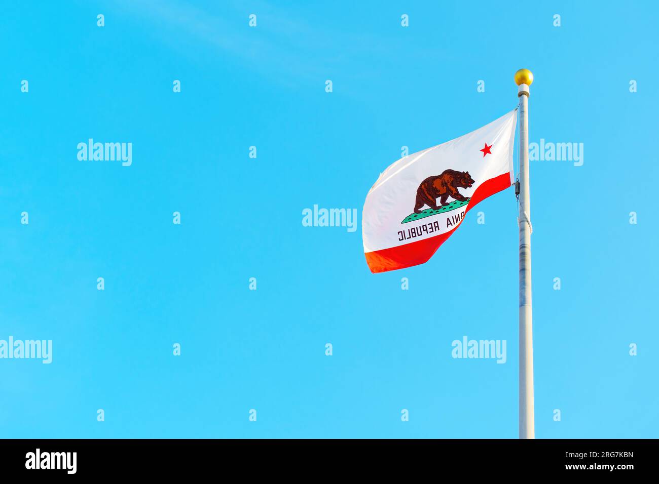 California state flag gracefully waving on a flagpole, set against a ...