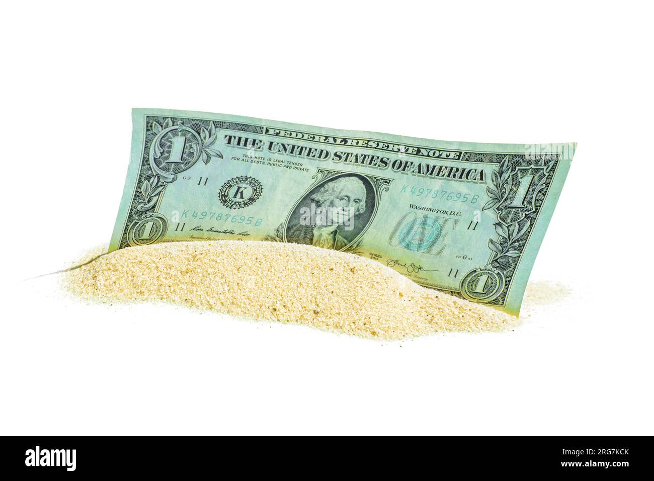 Single one-dollar bill placed amidst a pile of fine sand on a clean ...
