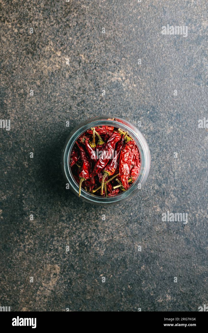 Red chili peppers in the jar. Top view Stock Photo - Alamy