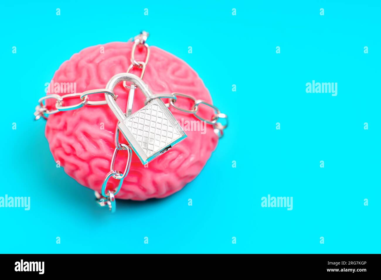 Human brain model surrounded by chains and secured with a padlock on ...