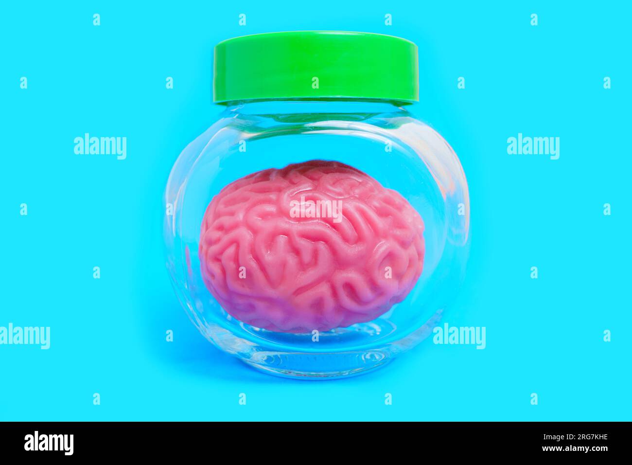 Close-up of a toy human brain preserved in a glass jar. Futuristic ...
