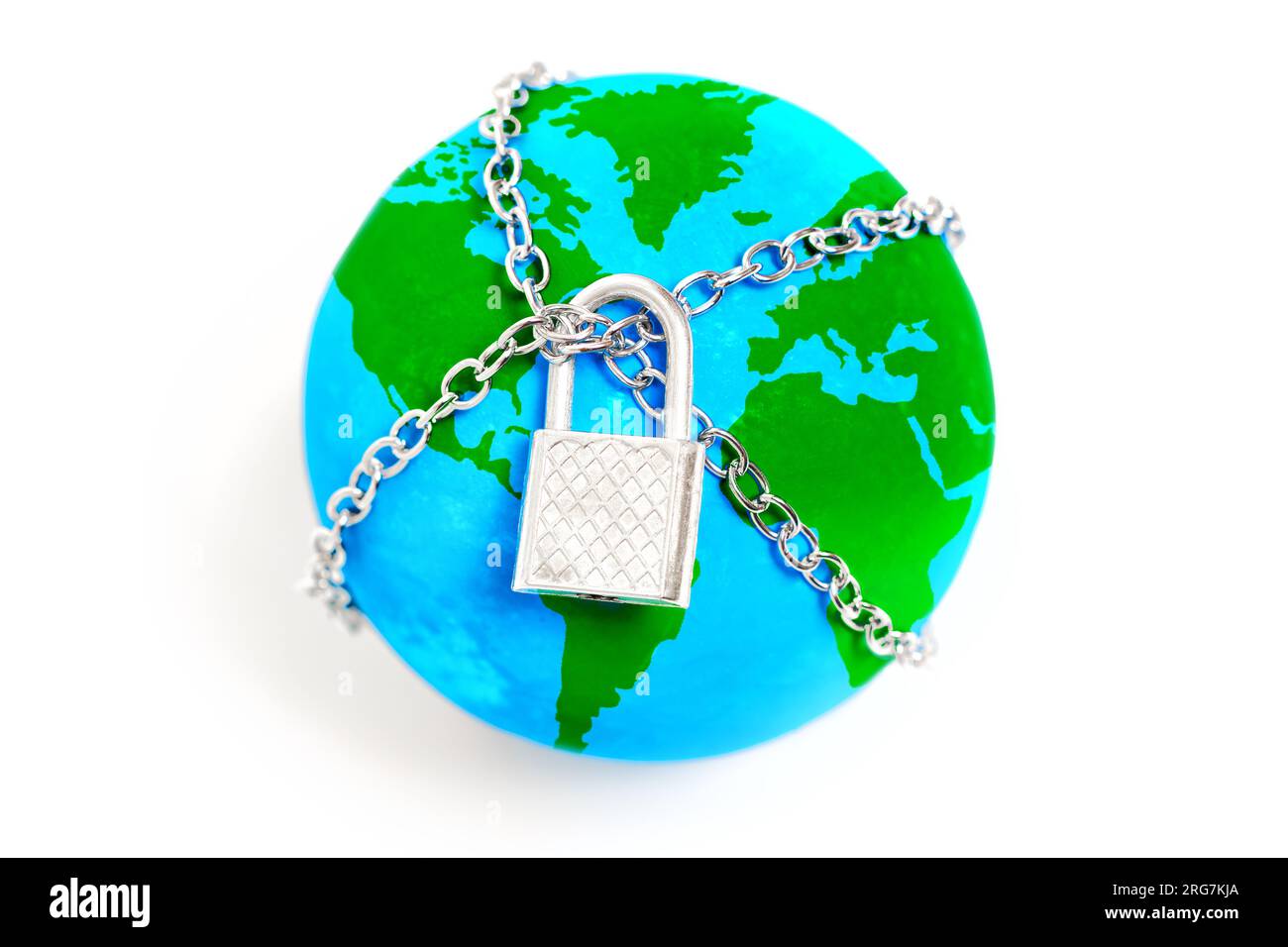 Close-up shot of a globe model bound by chains and secured with a ...