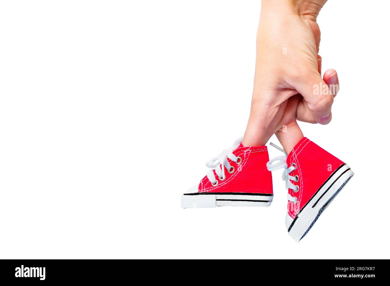 Female hand walking with fingers wearing red canvas shoes isolated on ...