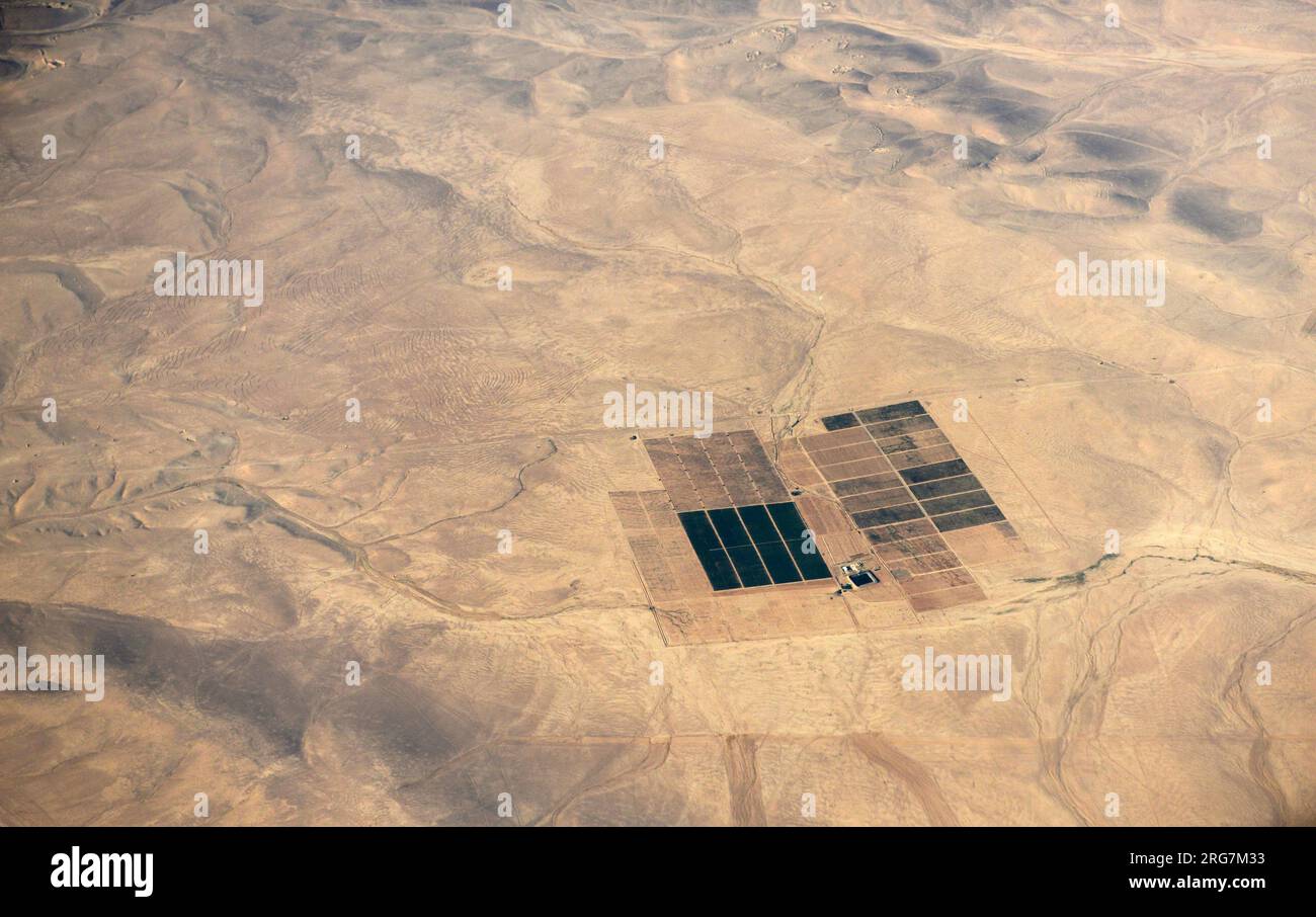 Aerial view of the Jordanian desert with small agricultural farms in ...