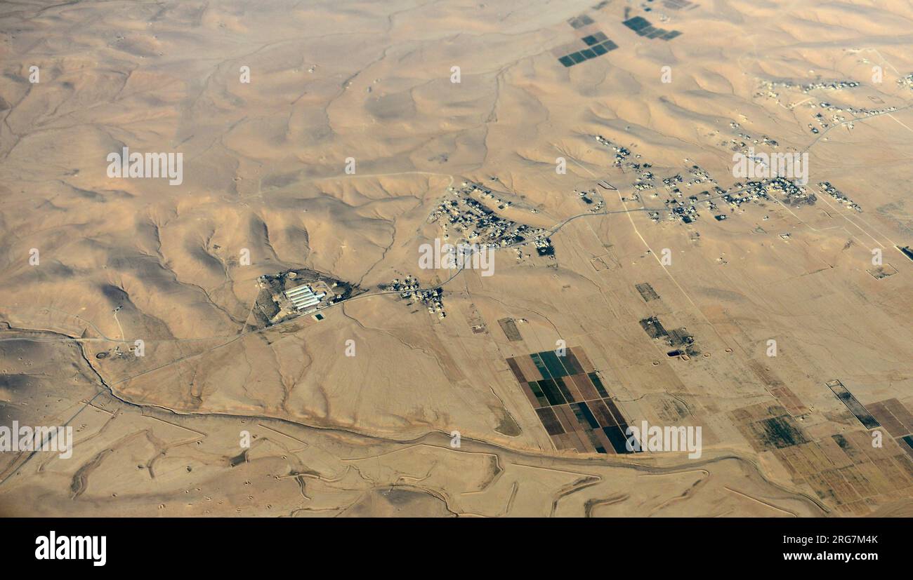 Aerial view of the Jordanian desert with small agricultural farms in ...