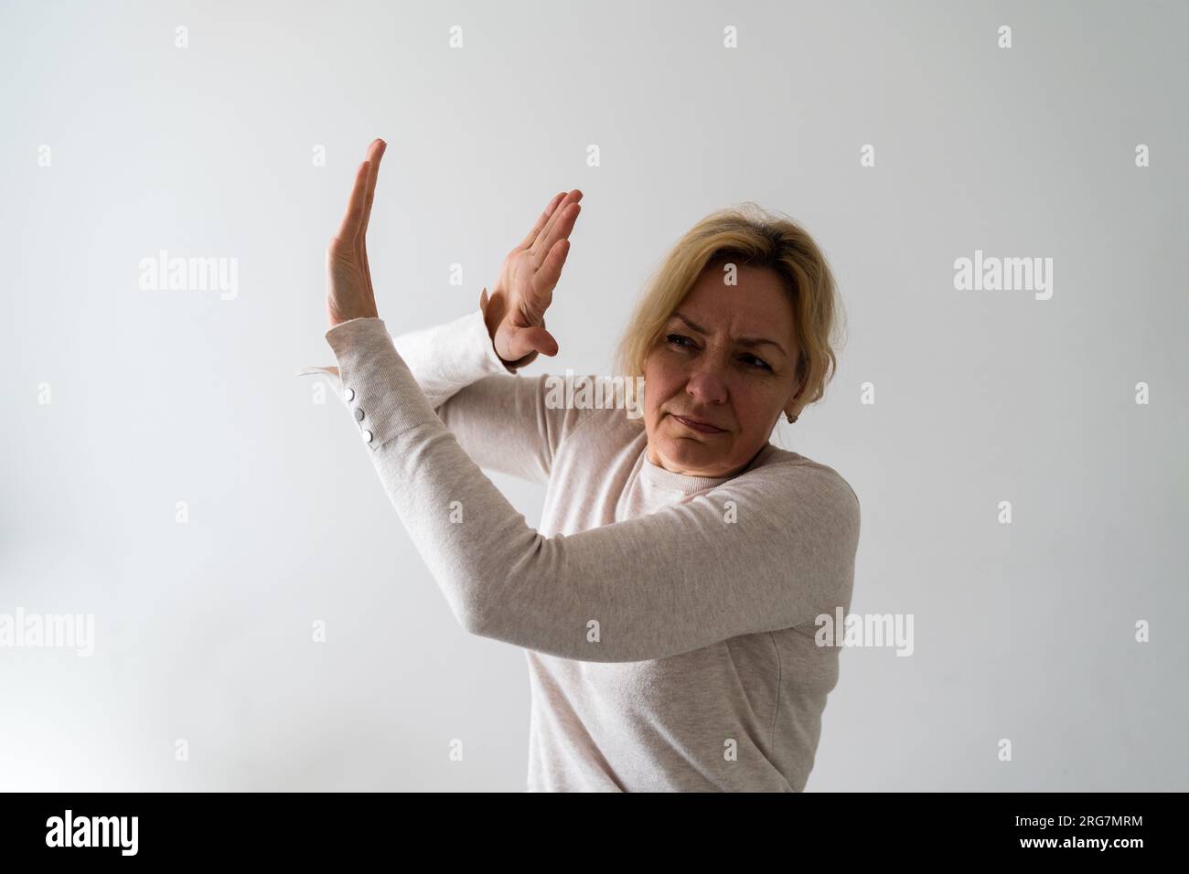 Mature woman defending at home Stock Photo - Alamy