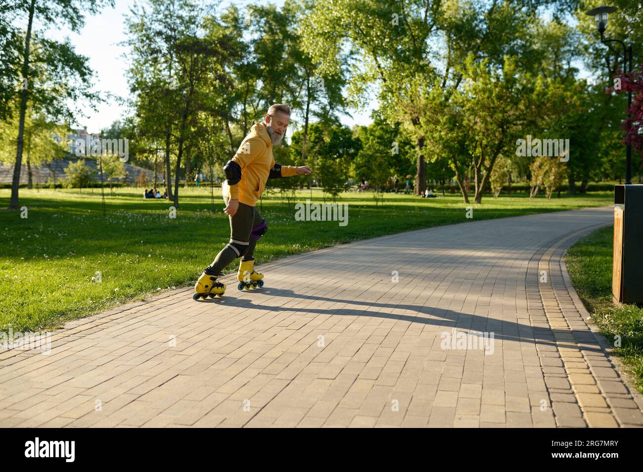 Senior man moving fast on roller skates outdoors Stock Photo - Alamy