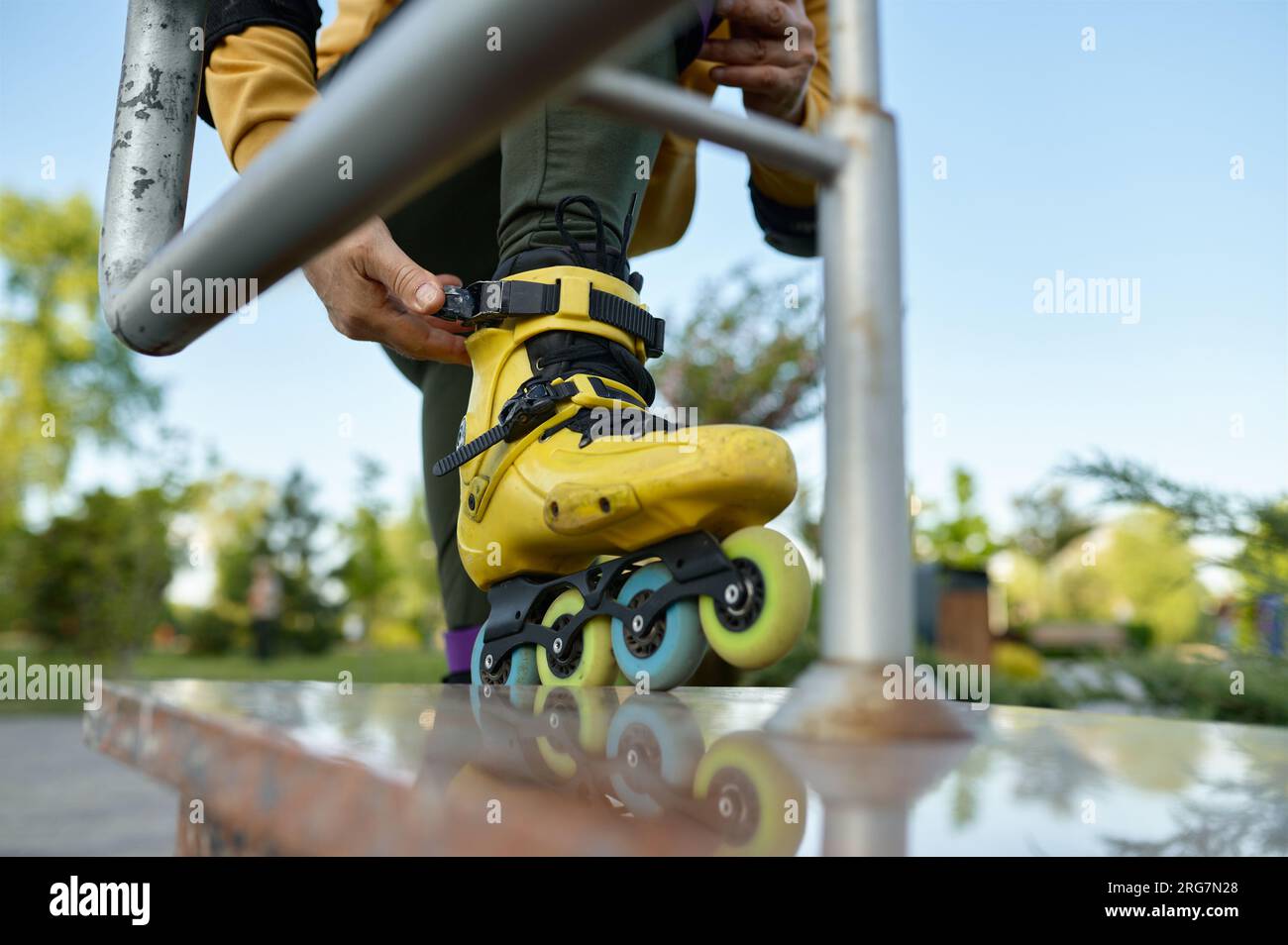 Closeup view on male leg wearing roller skates and hand snapping lock ...