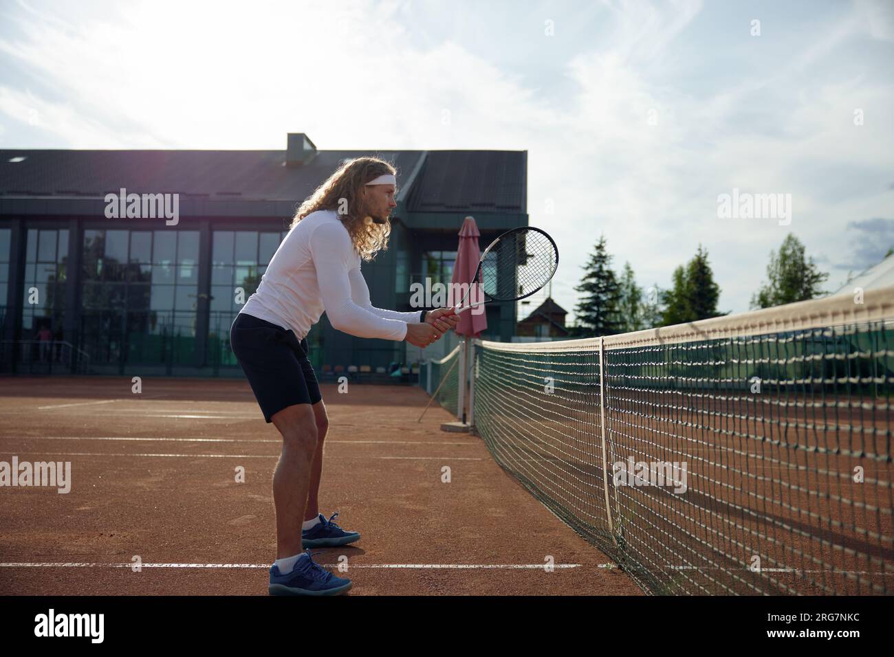 Professional tennis player holding racket standing front of net Stock ...