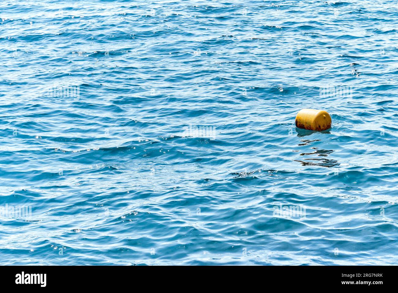 Yellow buoy marking border of swimming zone for resting tourists ...