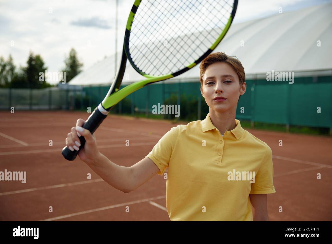 Portrait of young teenage woman tennis player with racket Stock Photo ...