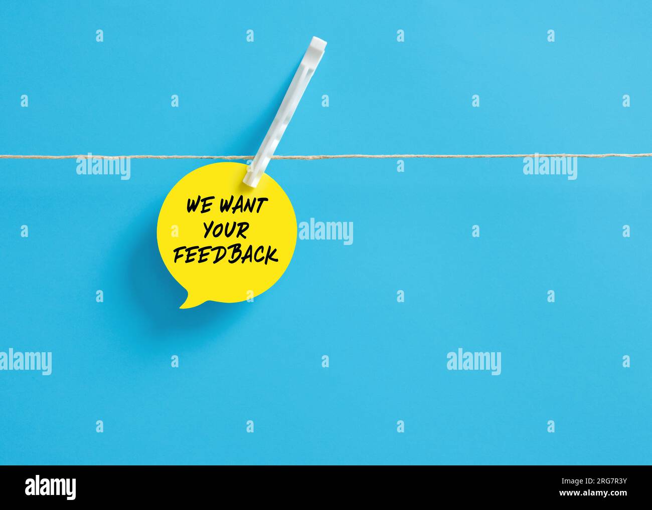 We want your feedback message on a speech bubble hanging on clothesline ...