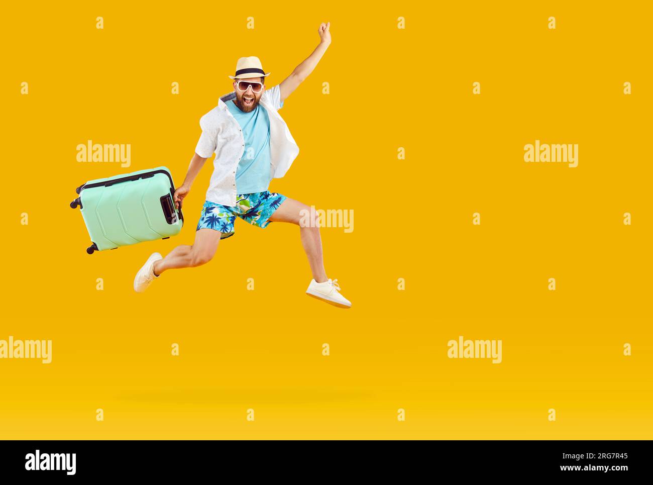 Happy man hurrying on summer holiday, holding suitcase and jumping up ...