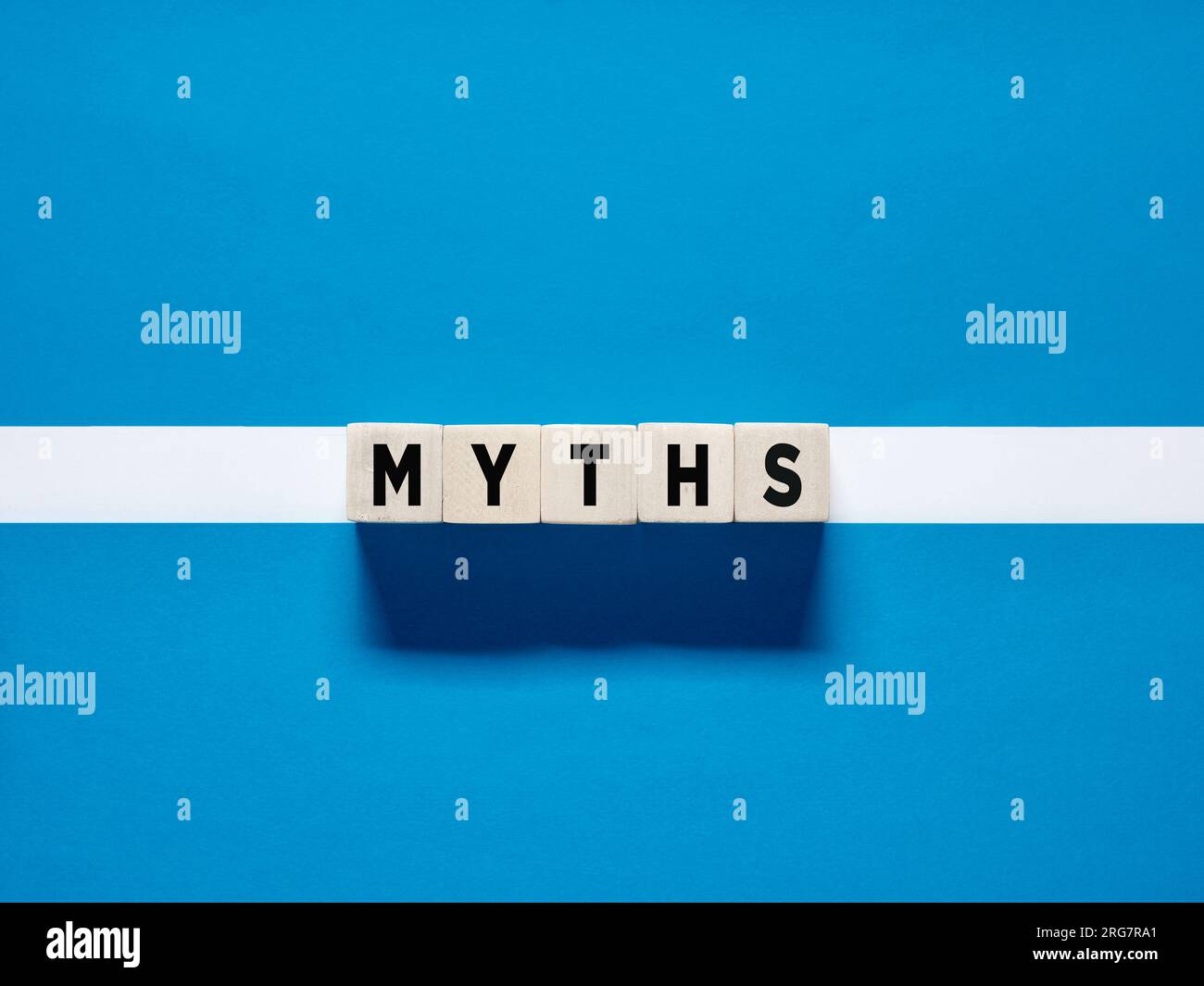 The word Myths on wooden cubes on blue white background Stock Photo - Alamy