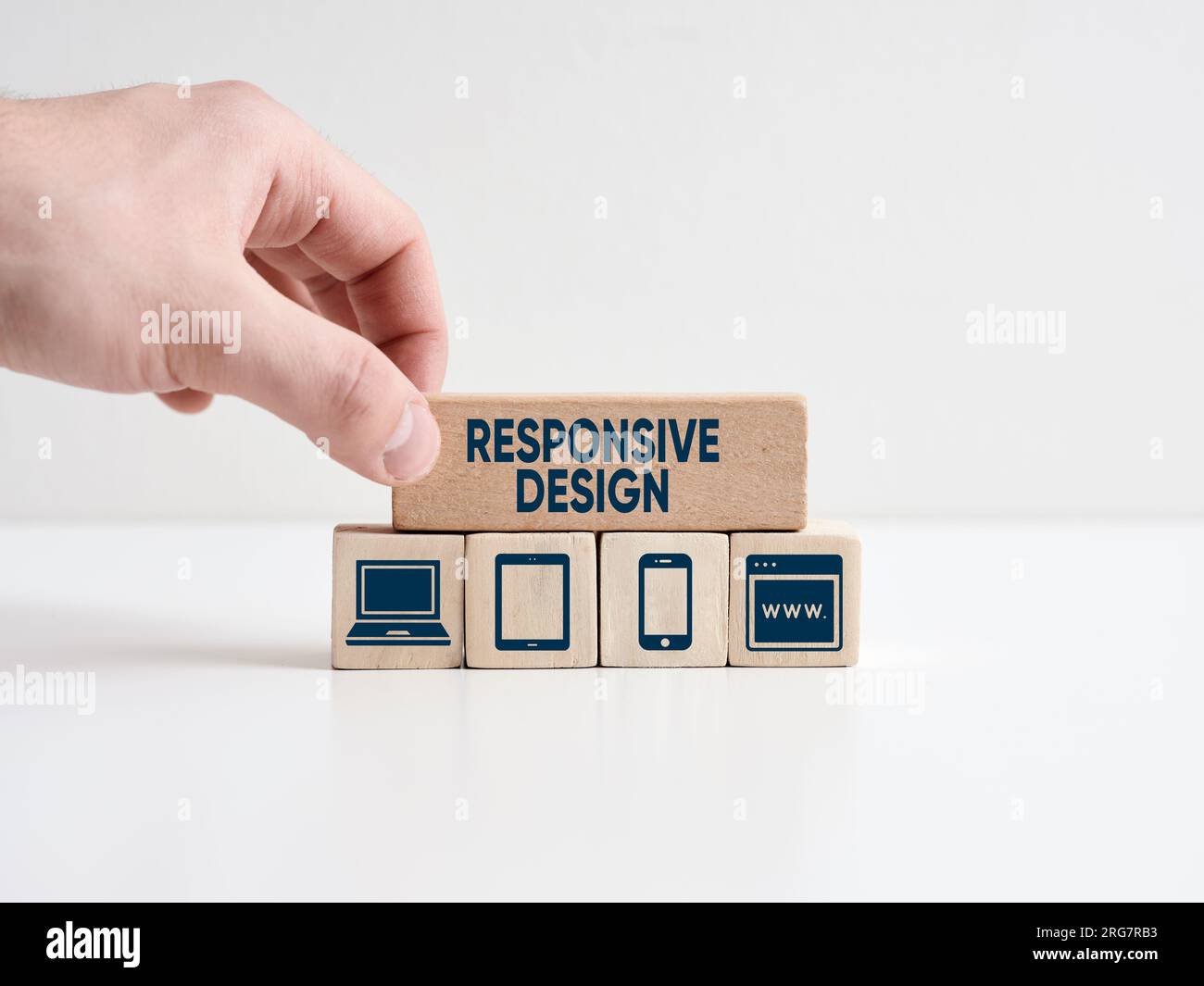 Responsive design concept. Web design. Hand places wooden block with ...