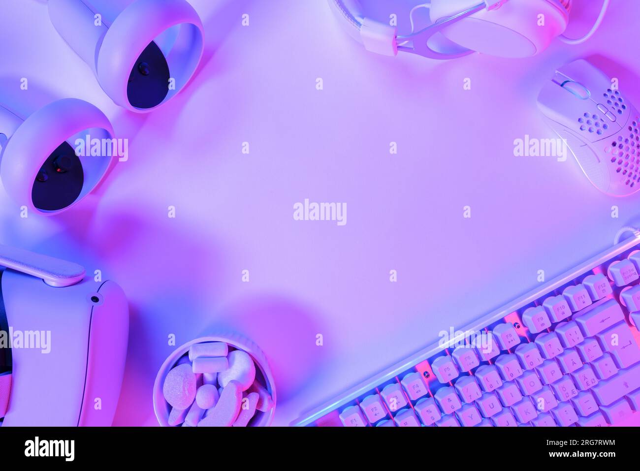 Gaming accessories on purple desk Stock Photo - Alamy