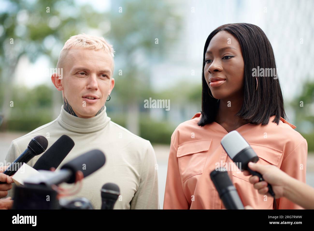Positive company representative talking to Stock Photo - Alamy