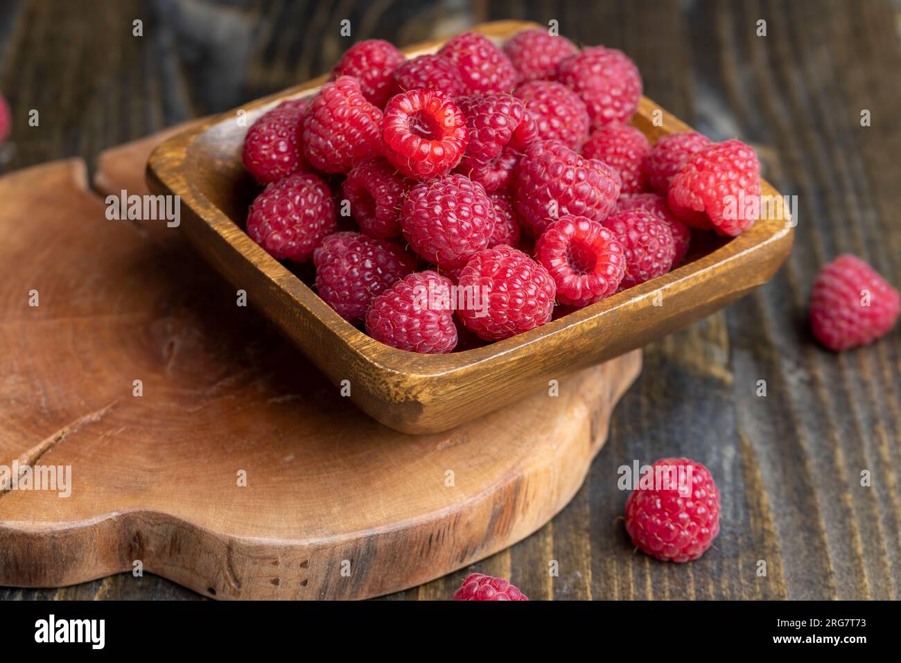 The harvest of red ripe raspberries is on the board, the last autumn ...