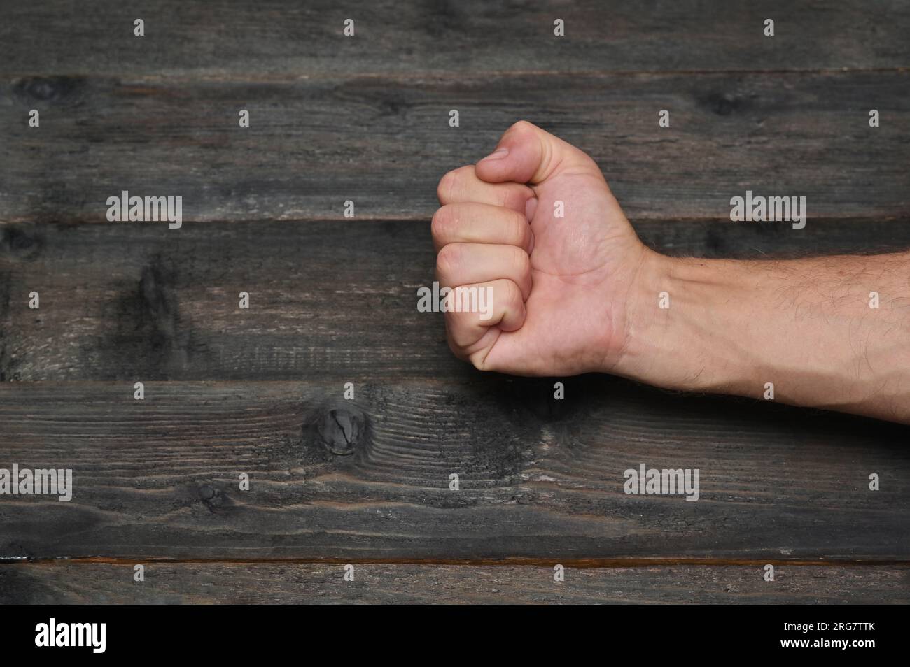 The man's palm is clenched into a fist Stock Photo - Alamy